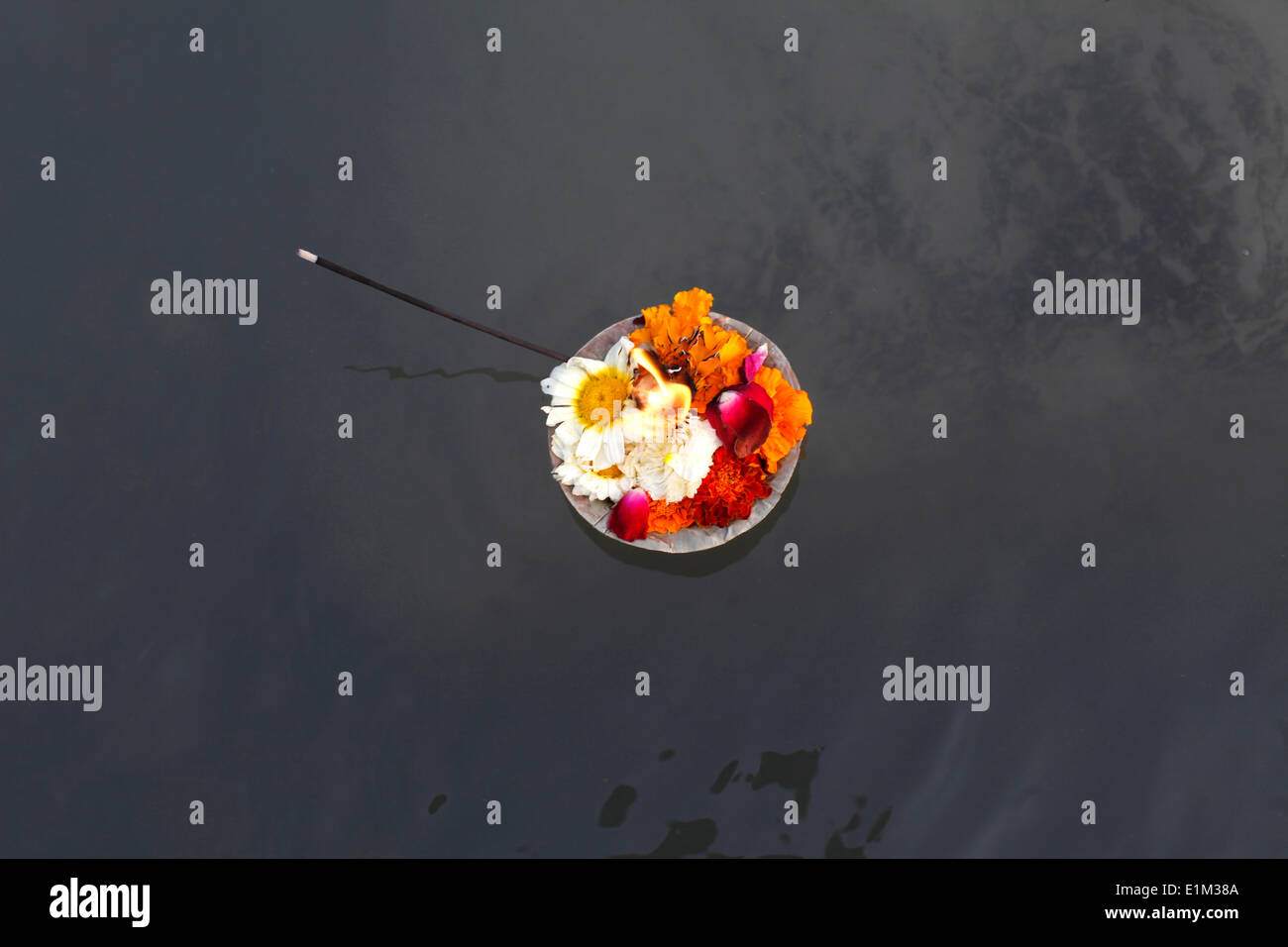 Diya (floral float with incense) floating on the Ganges Stock Photo - Alamy