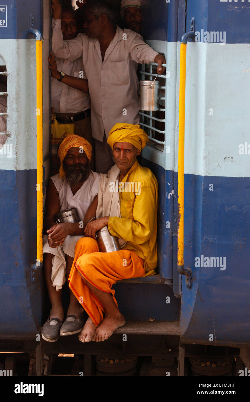 Passengers standing and sitting between railway cars Stock Photo - Alamy