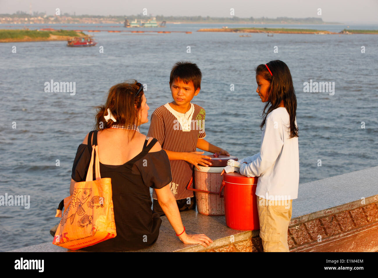 Children selling water in Phnom Penh Stock Photo - Alamy