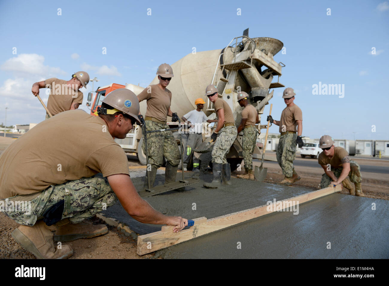 U.S. Sailors assigned to Naval Mobile Construction Battalion 11 pour ...