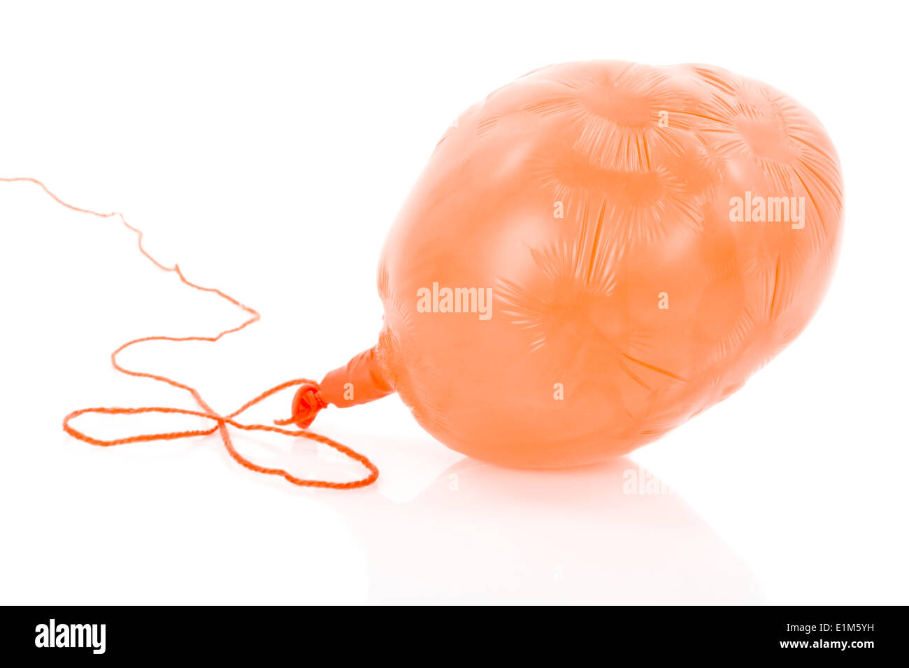 Deflated orange balloon at a rope; isolated over white background Stock ...