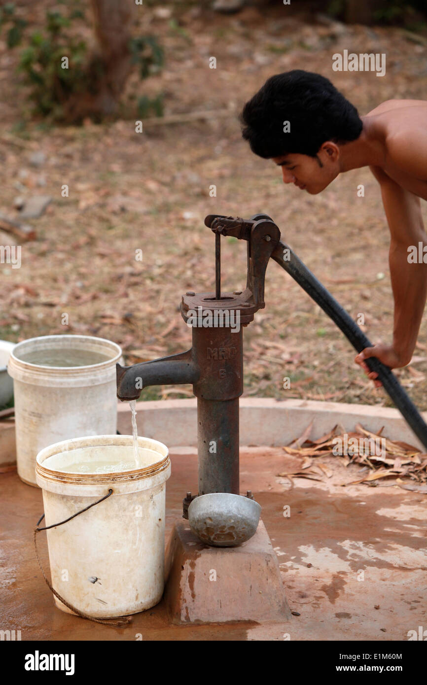 Young man pumping water Stock Photo - Alamy
