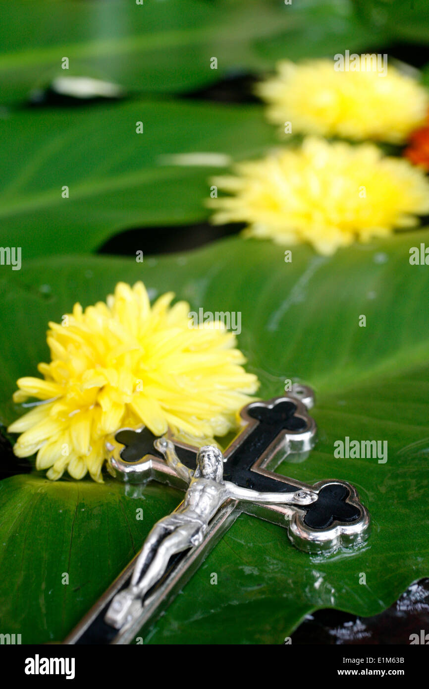 Crucifix and flowers Stock Photo - Alamy