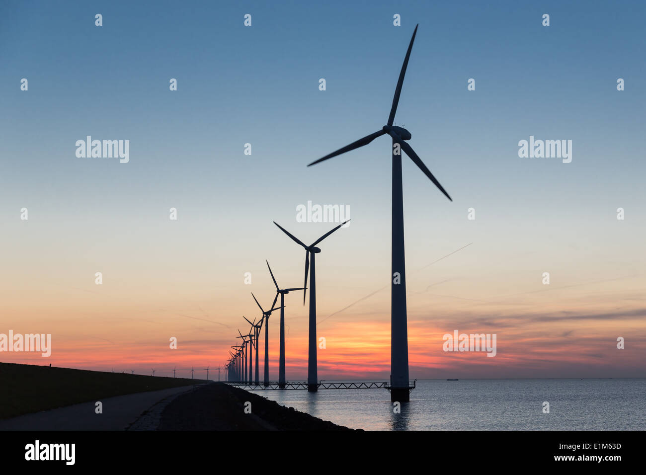 Long row Dutch offshore wind turbines at beautiful sunset Stock Photo ...