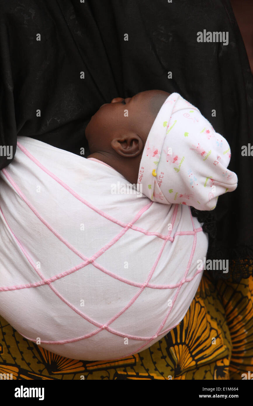 Mother carrying her baby on her back Stock Photo - Alamy