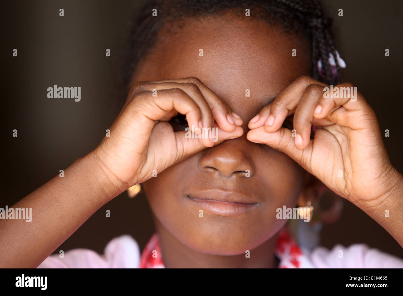 African girl playing with her fingers Stock Photo - Alamy