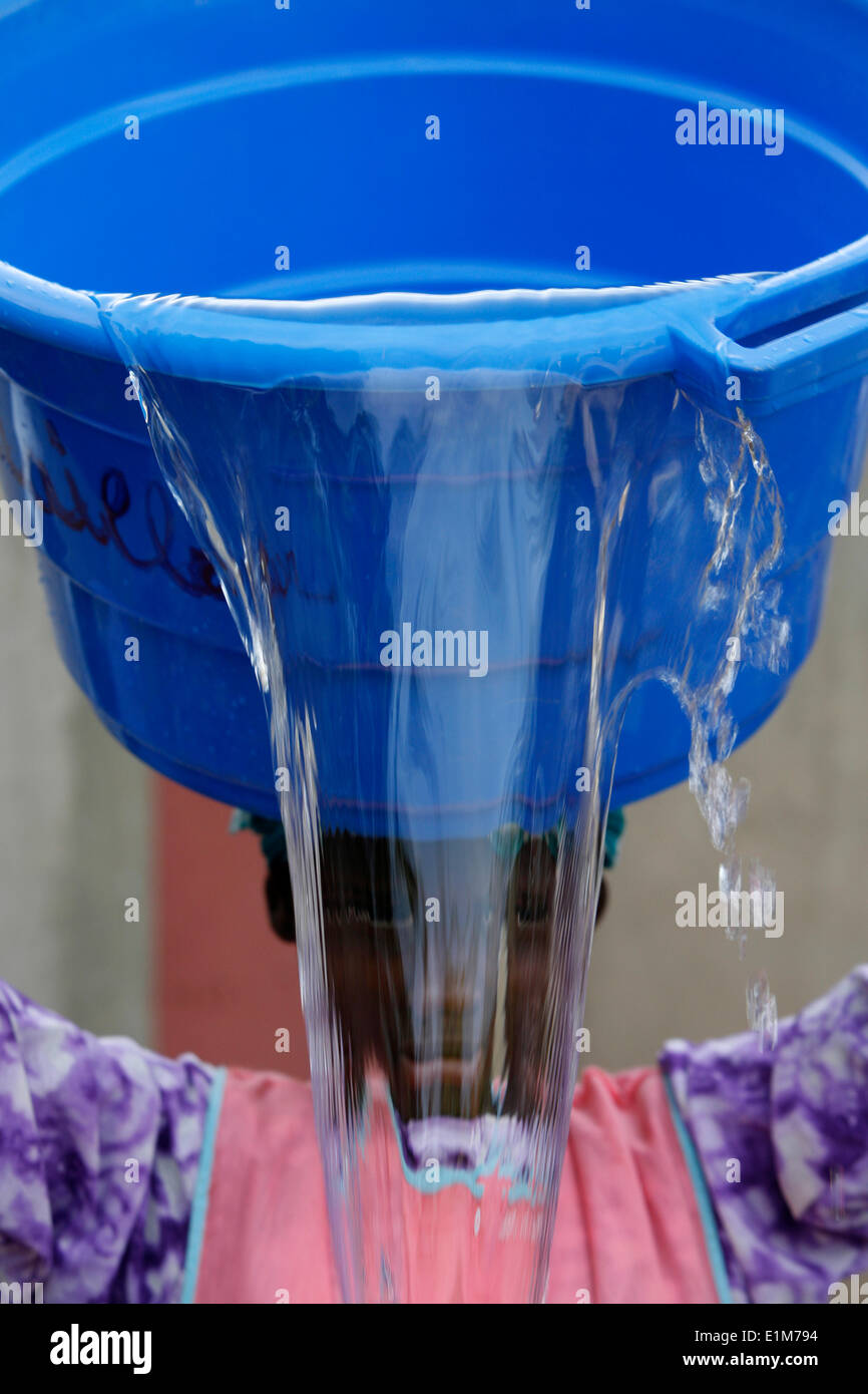 Woman pouring water Stock Photo - Alamy