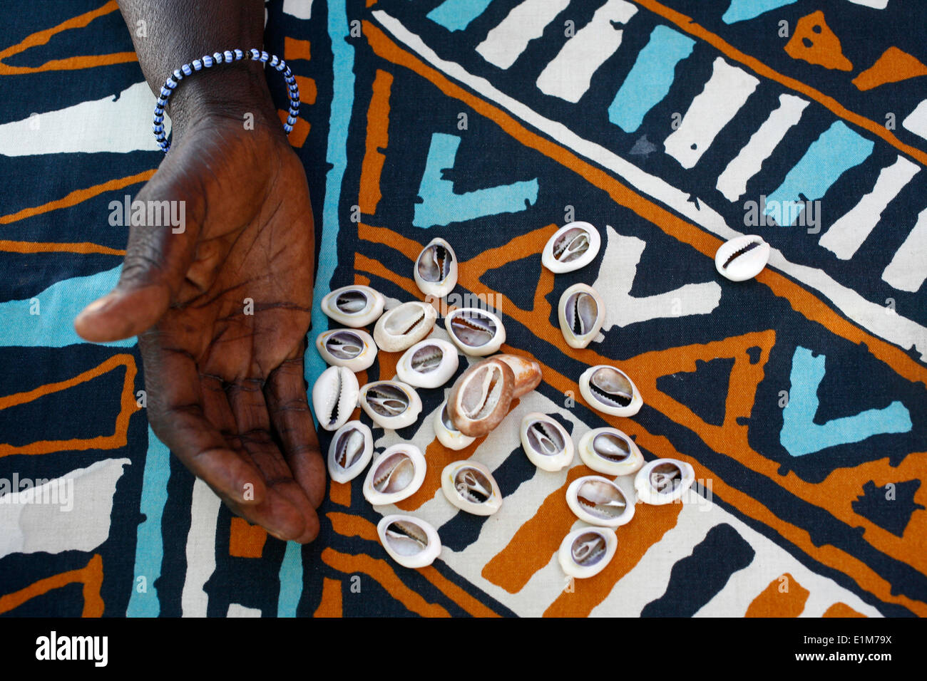 Fortune telling with cauri shells Stock Photo - Alamy