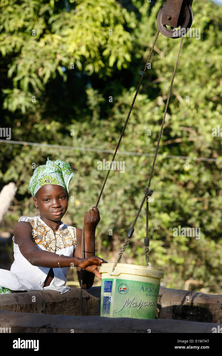 Girl fetching water from a well Stock Photo - Alamy
