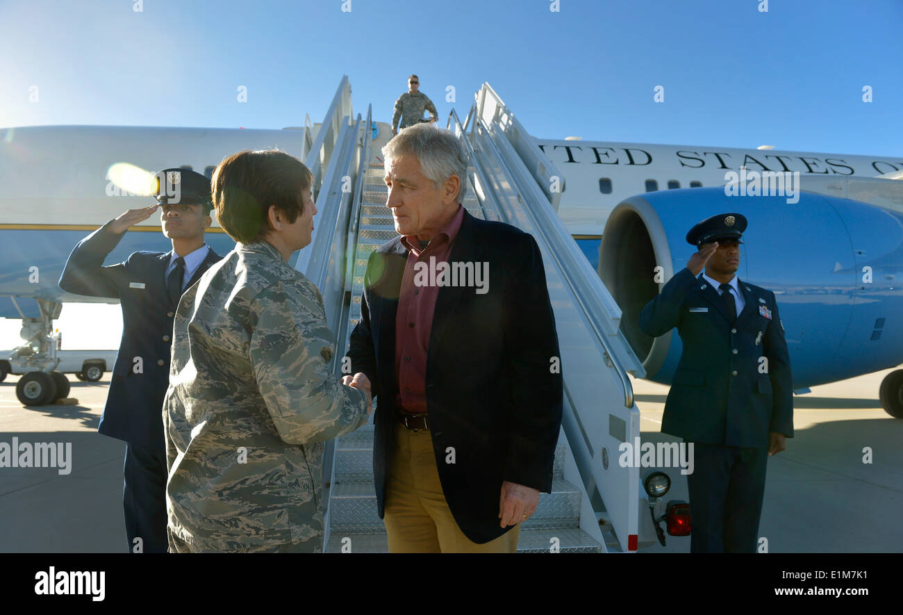 Secretary of Defense Chuck Hagel, center right, is greeted by U.S. Air ...