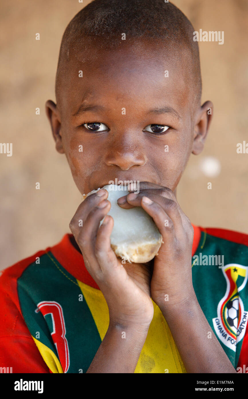 Boy eating a sweet potato Stock Photo - Alamy