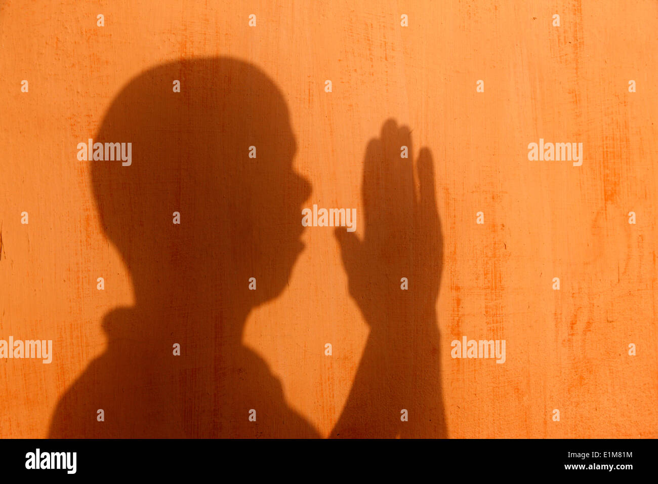 Shadow of a praying man Stock Photo - Alamy