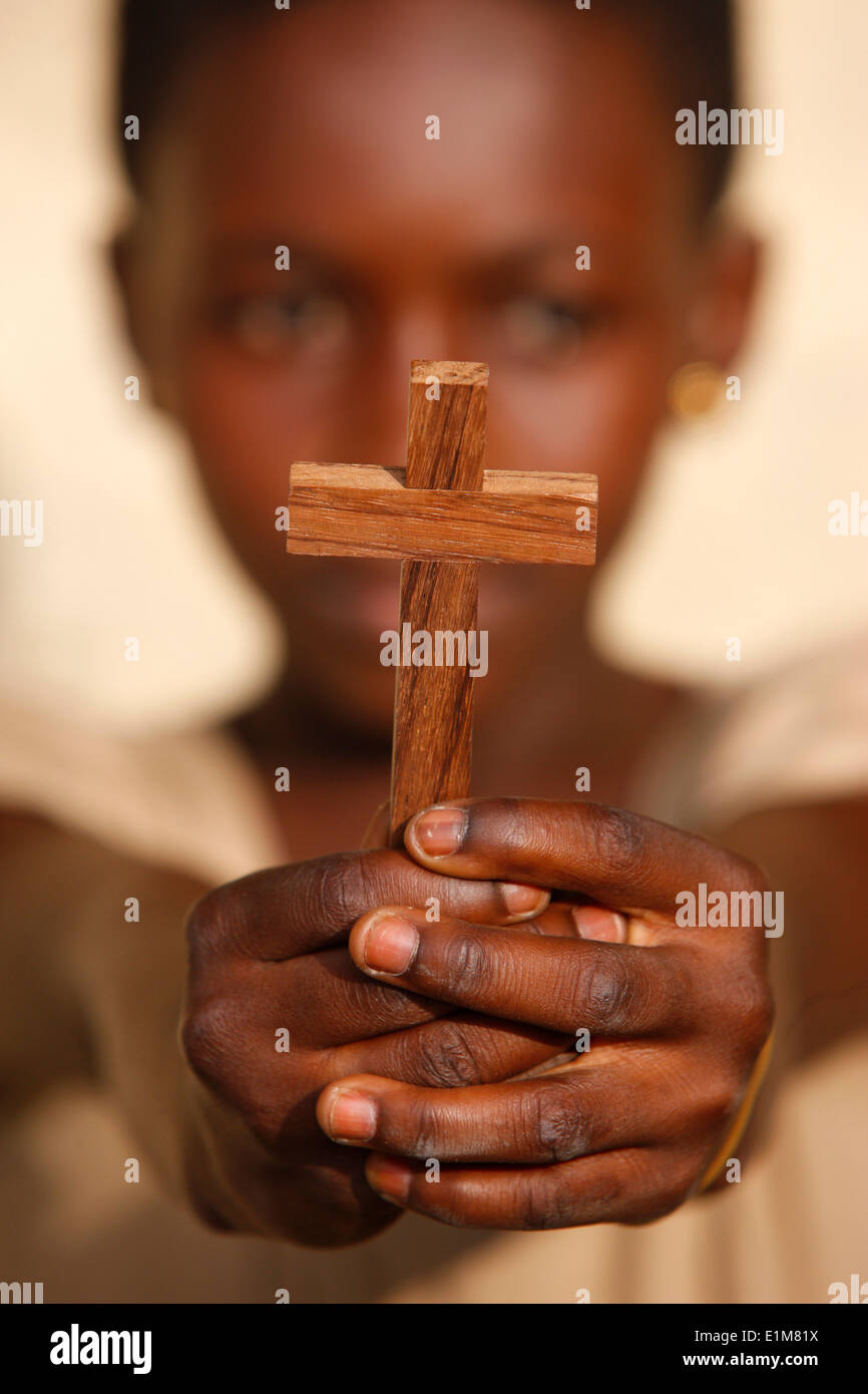 Young African christian holding a cross Stock Photo - Alamy