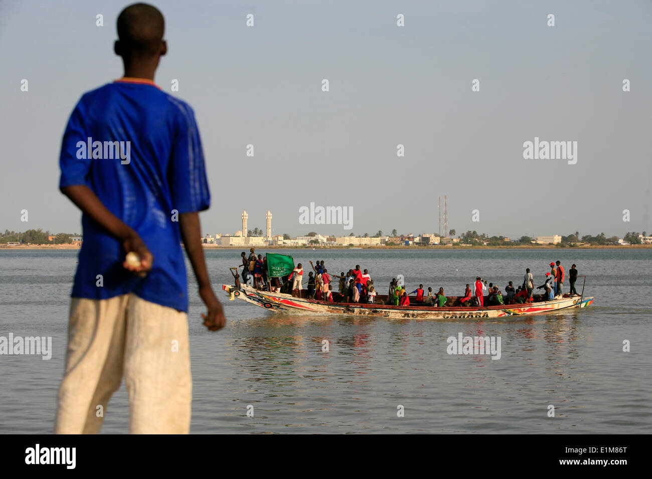 Boy looking at a boat Stock Photo - Alamy