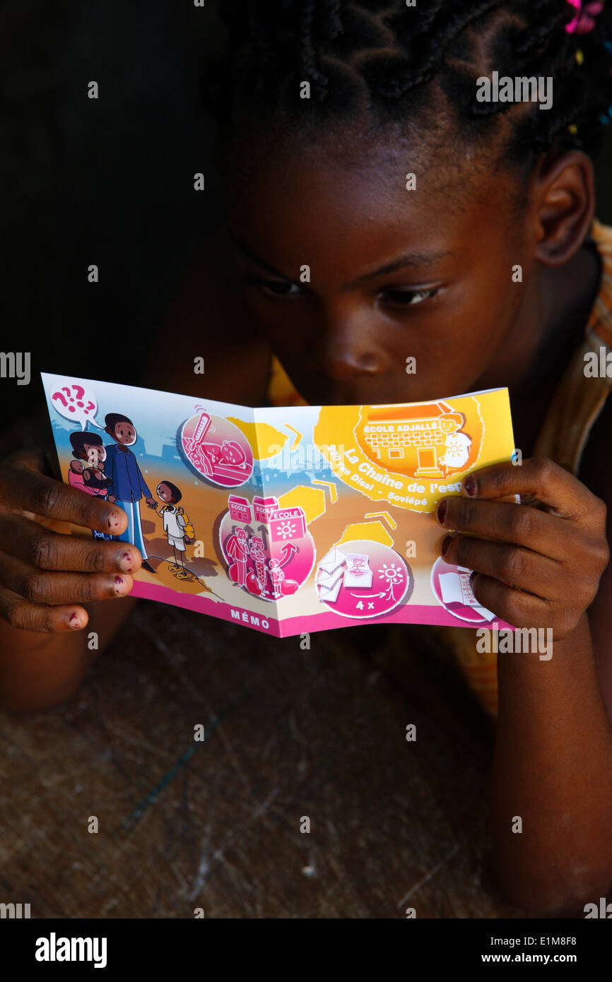 Child reading a pamphlet Stock Photo - Alamy
