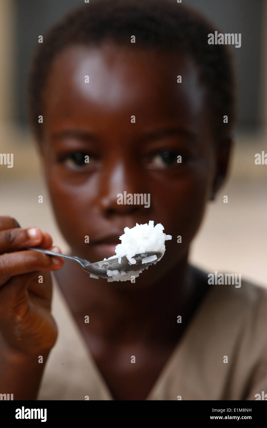 African girl eating rice Stock Photo - Alamy