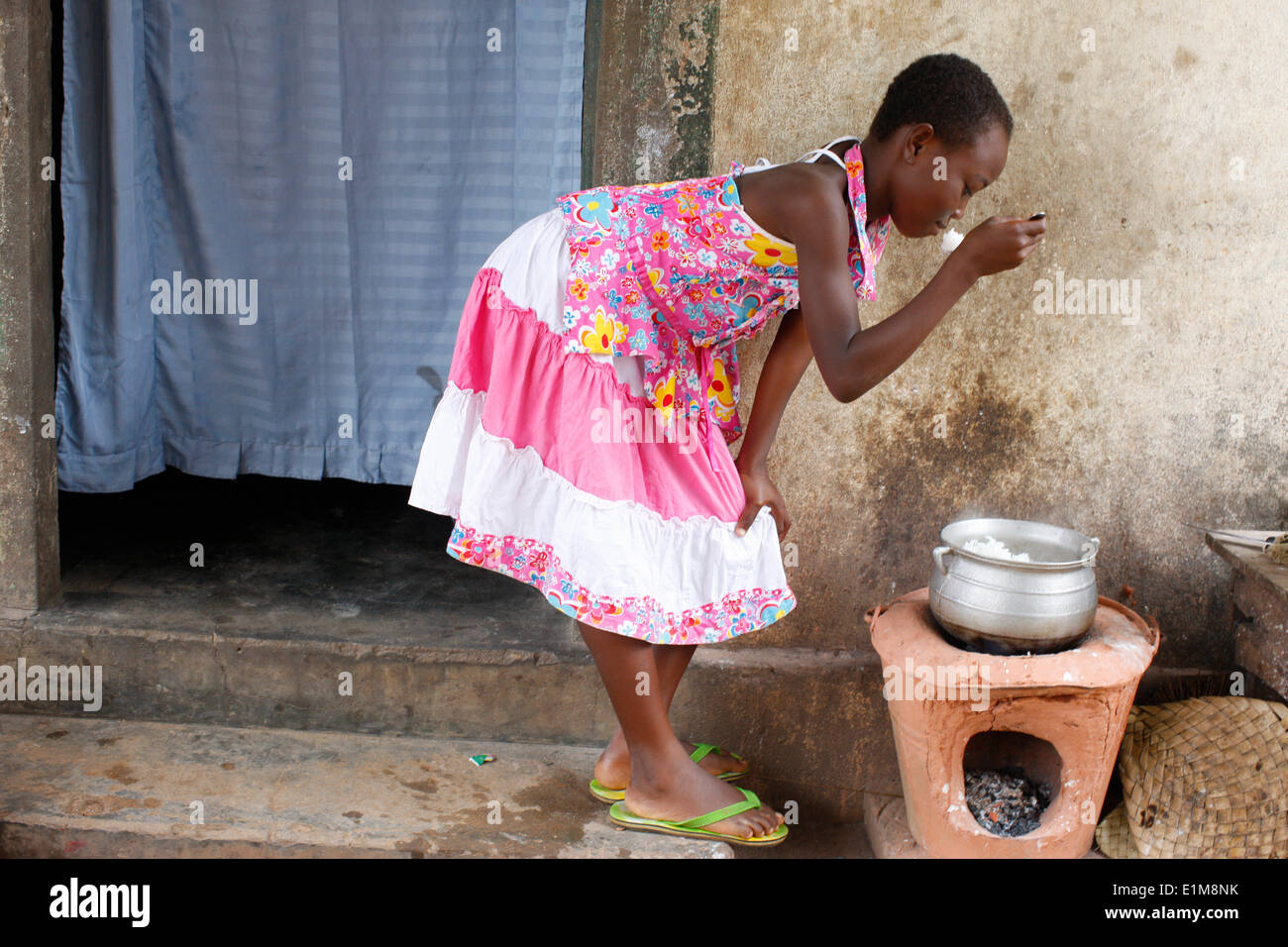 African girl eating rice Stock Photo - Alamy
