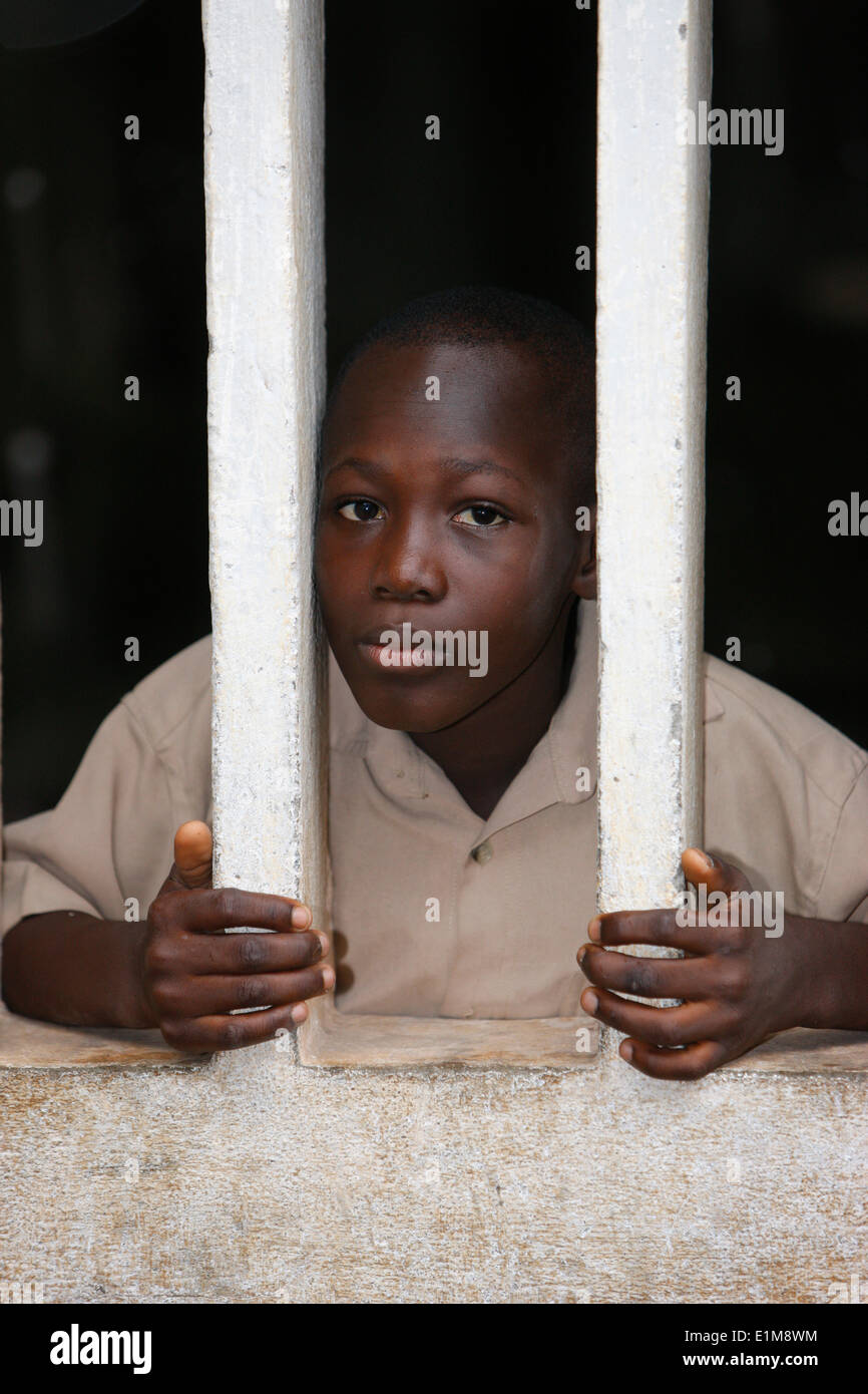 Boy behind bars hi-res stock photography and images - Alamy