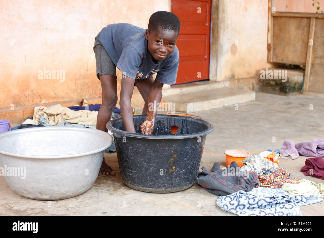Boy doing laundry Stock Photo - Alamy