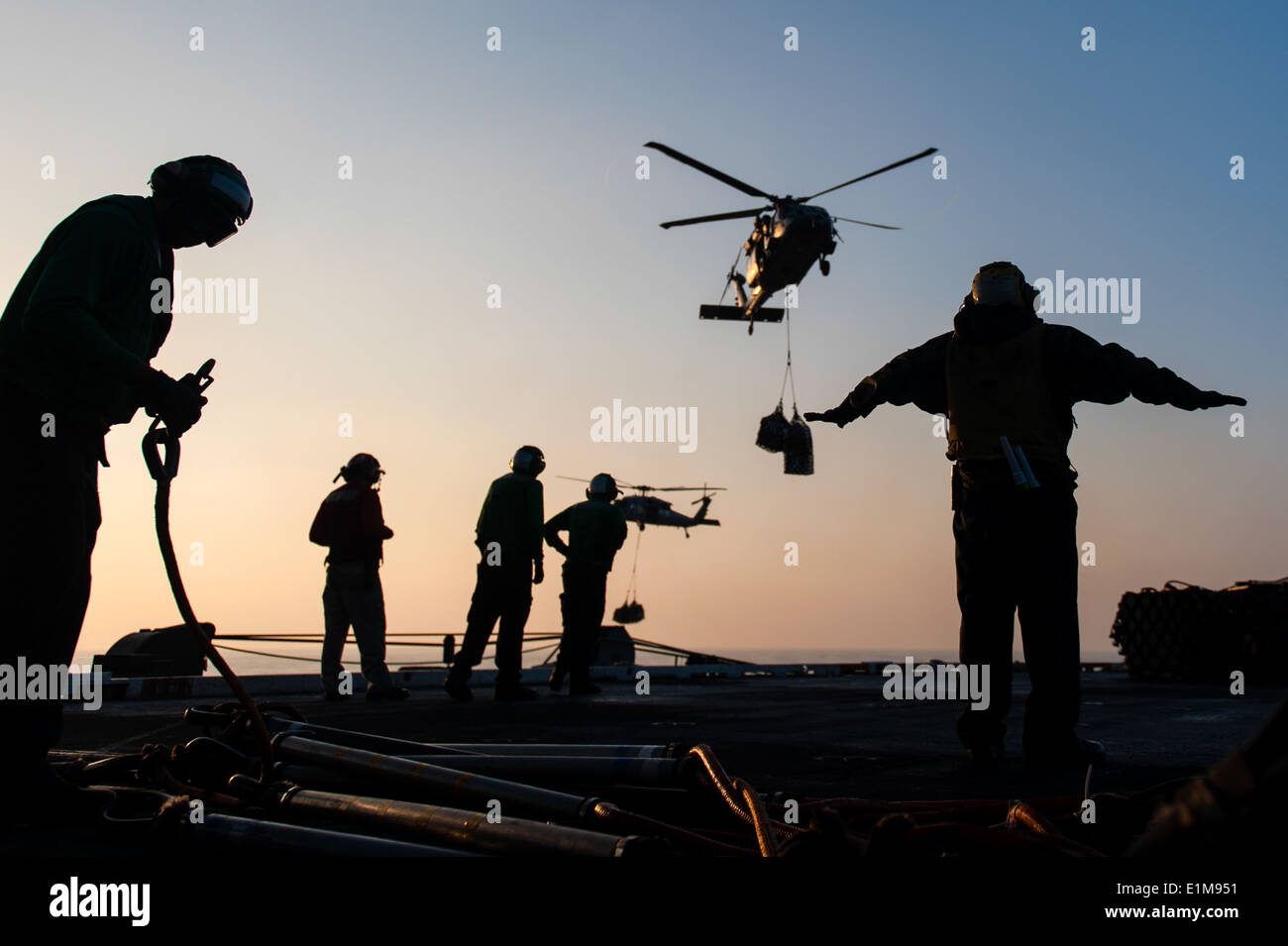U.S. Sailors direct an MH-60S Seahawk helicopter assigned to Helicopter ...