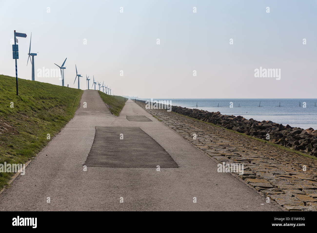 Dutch dike along the sea with wind turbines Stock Photo - Alamy