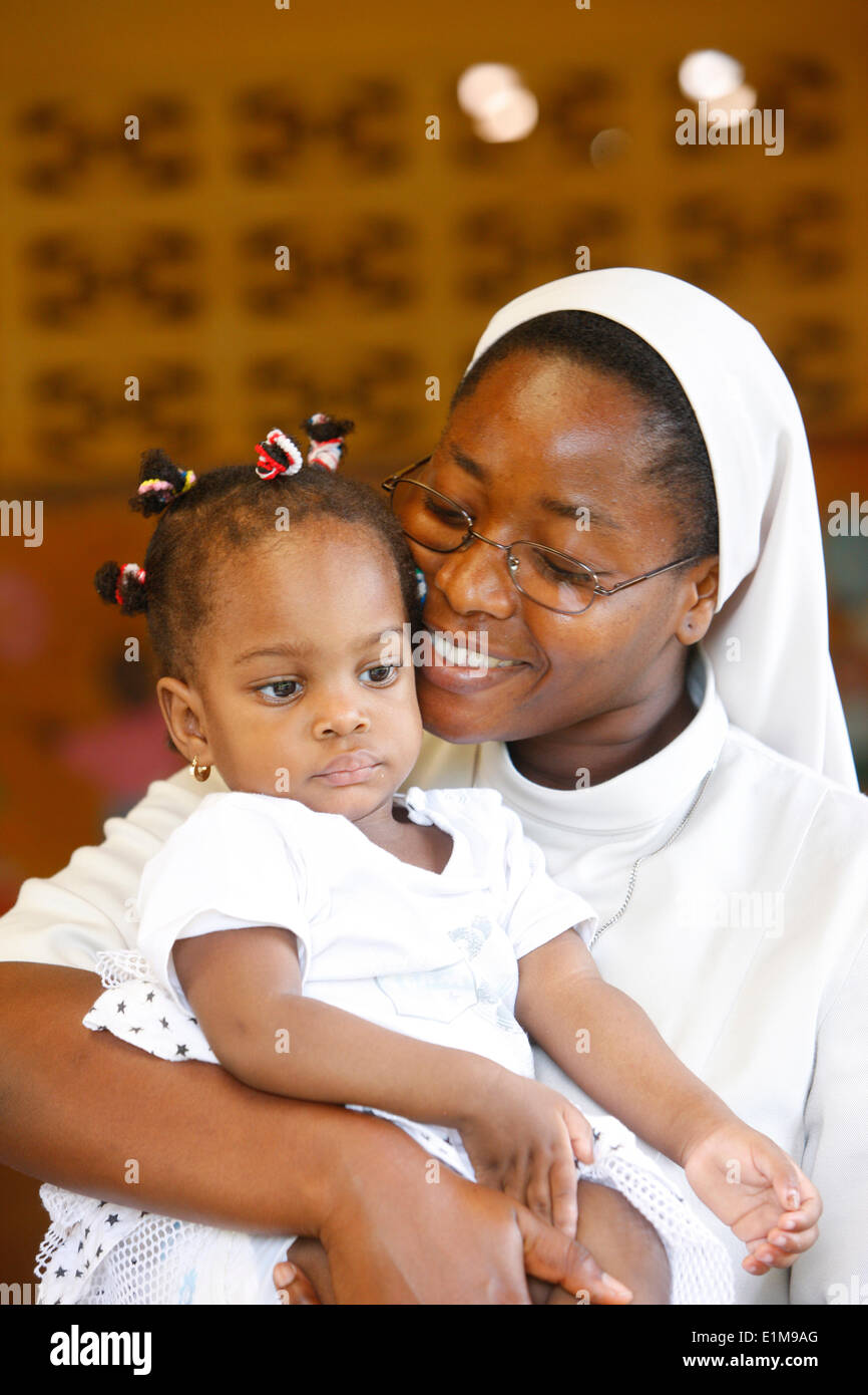 Nursery & Kindergarten run by catholic nuns Franciscan sister holding ...