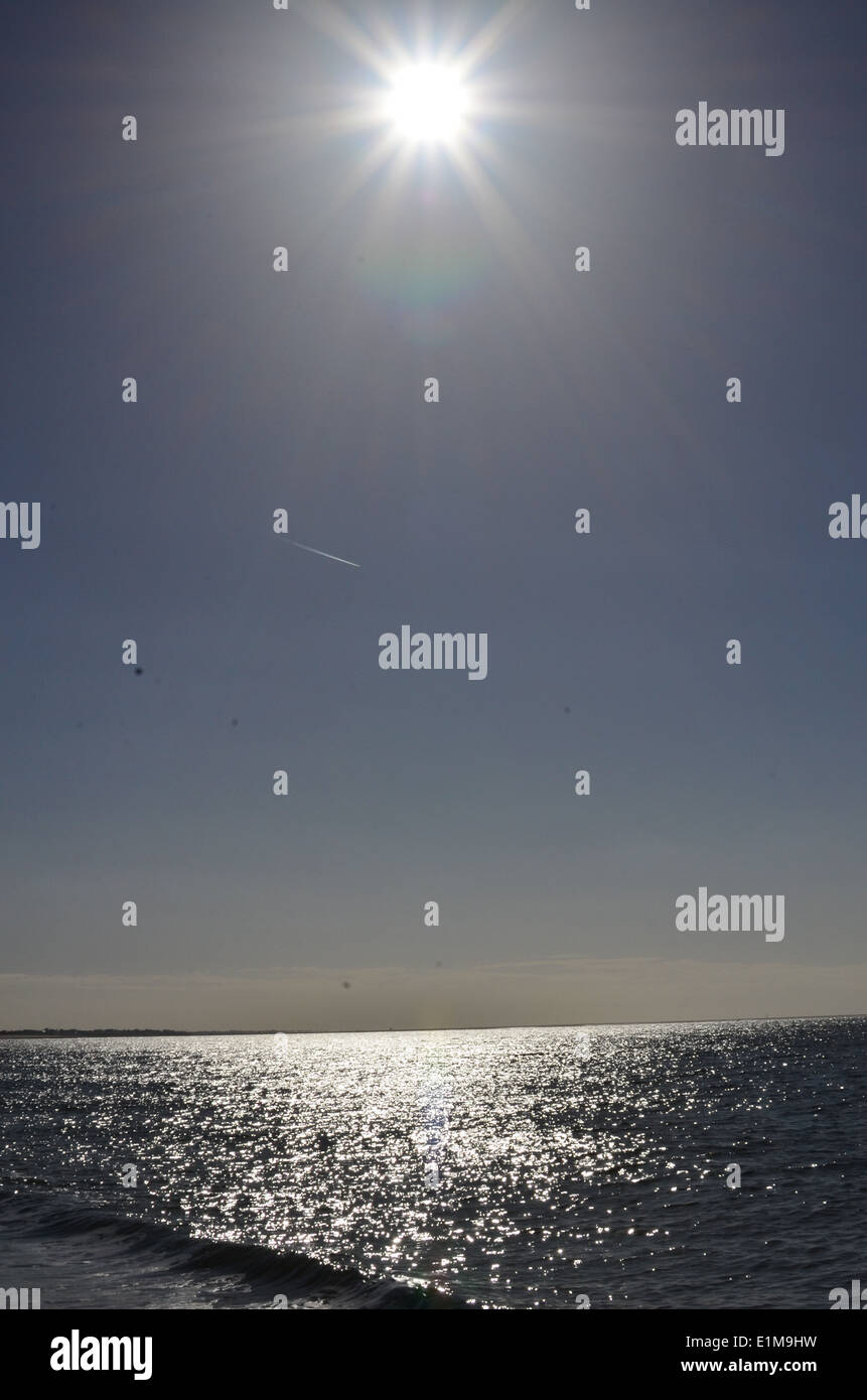 sea side with sun rise with clear blue sky , with plane going across ...