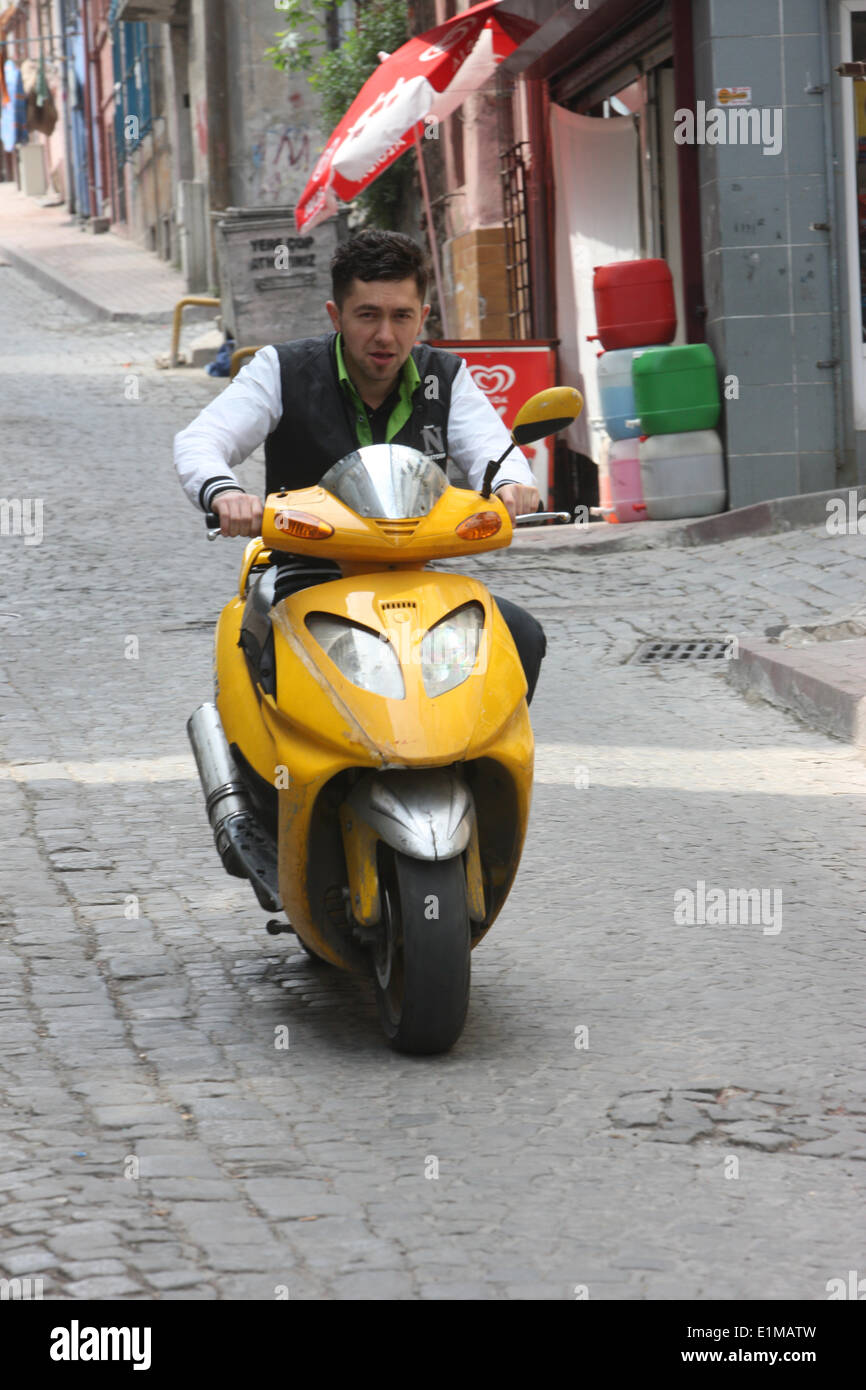 Man riding a scooter Stock Photo - Alamy