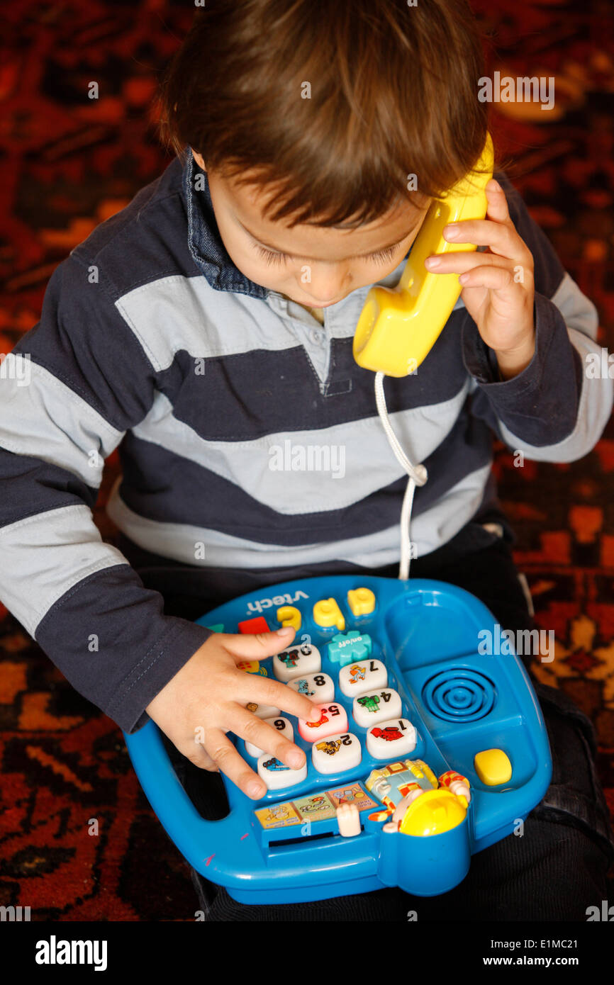 Boy playing with a toy phone Stock Photo - Alamy