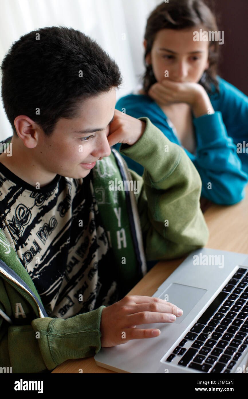 Teenagers using a computer Stock Photo - Alamy
