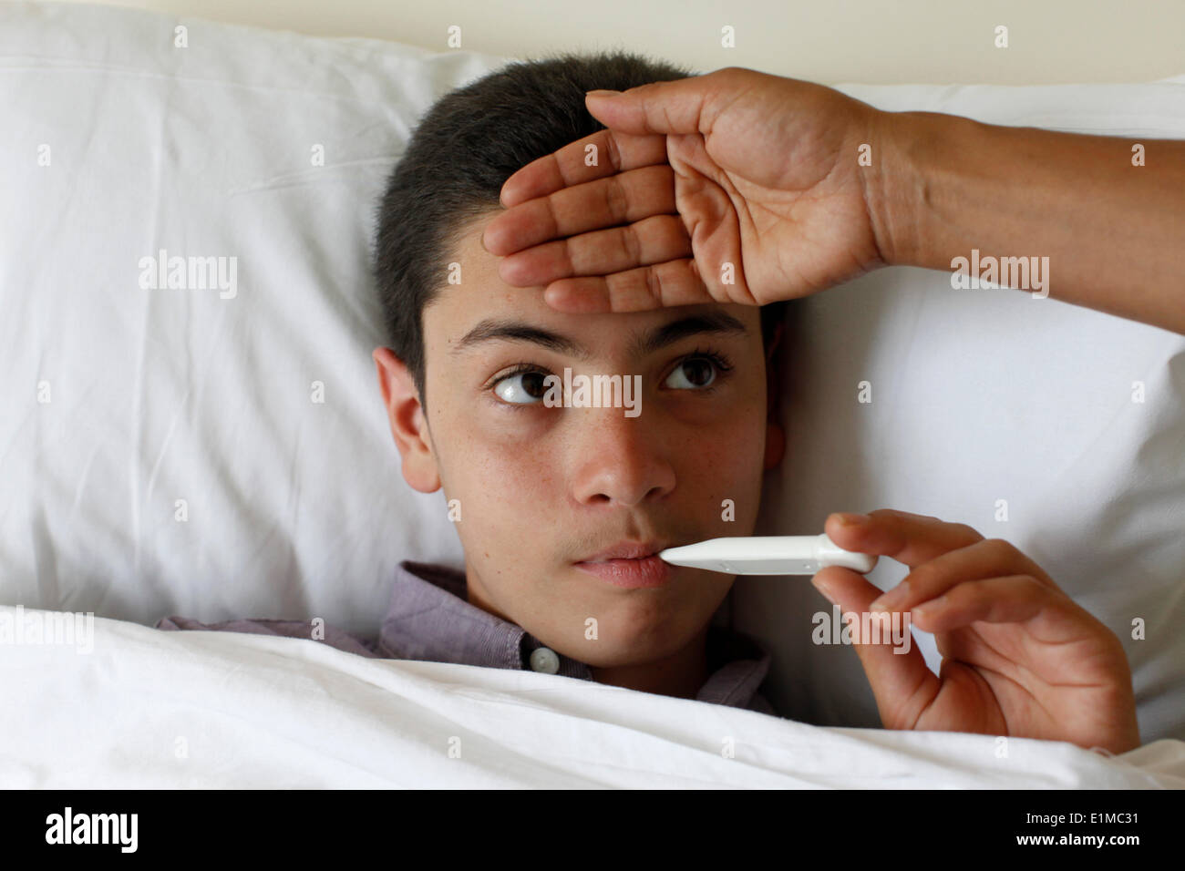 Sick boy taking a temperature Stock Photo - Alamy