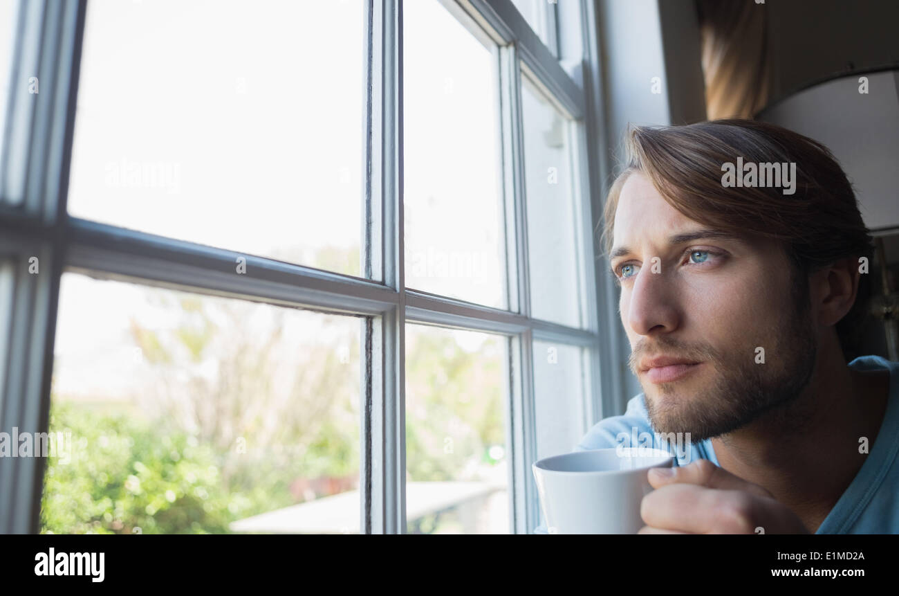 Thoughtful man looking out the window Stock Photo - Alamy