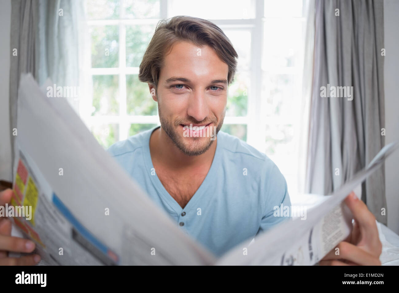 Reading newspaper home bedroom hi-res stock photography and images - Alamy