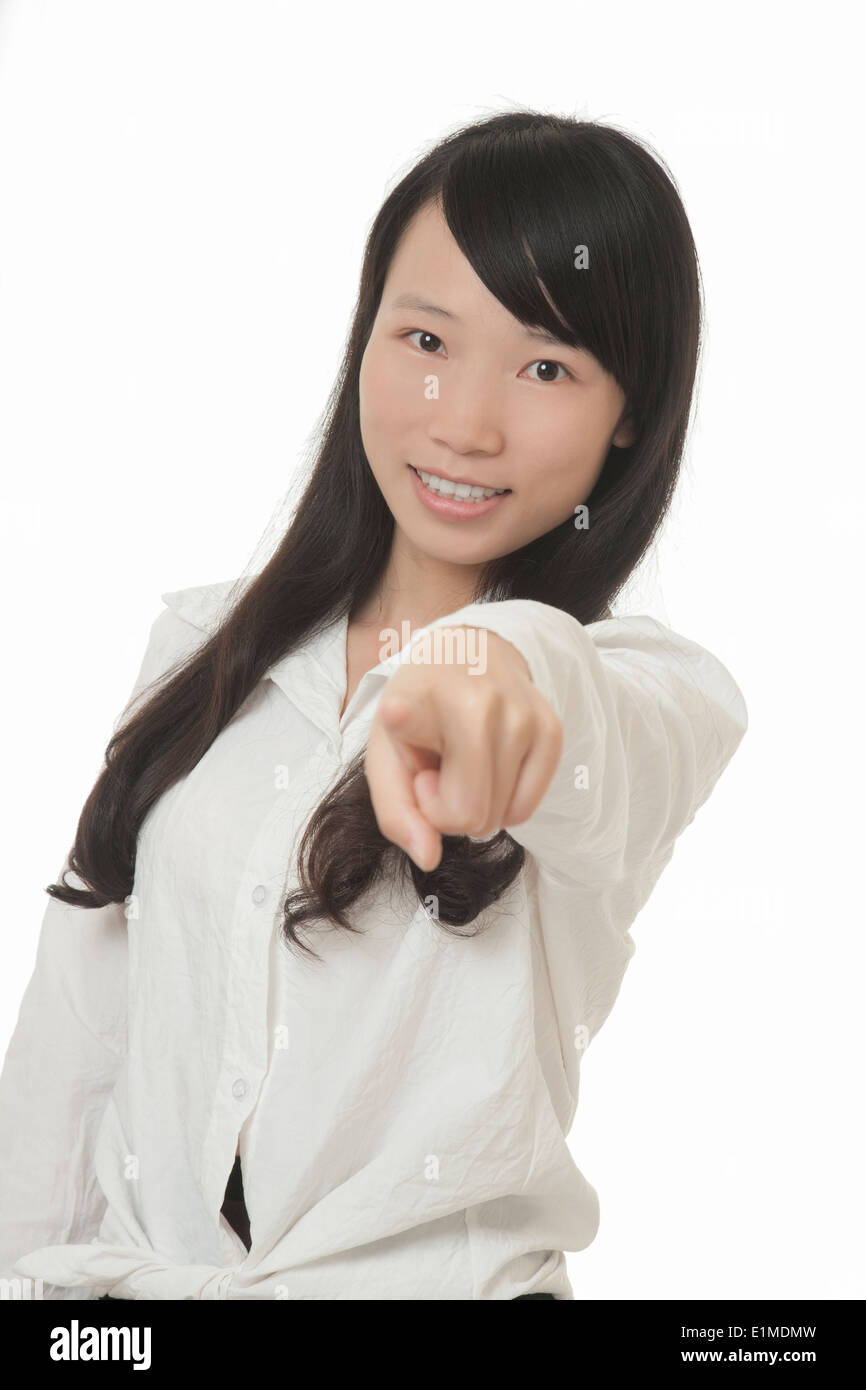 Beautiful Chinese woman pointing a finger at the camera isolated on a ...