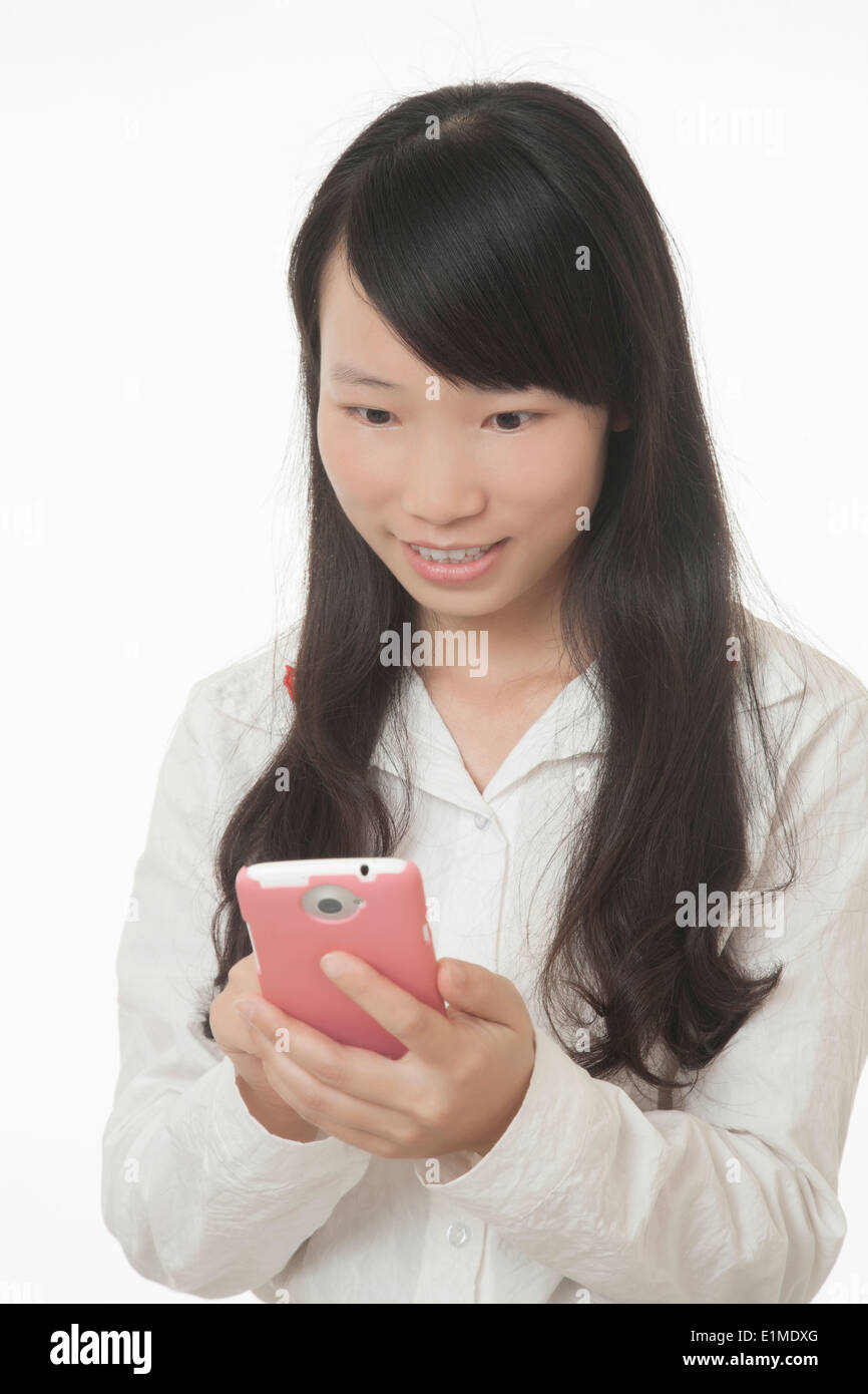 Beautiful Chinese woman using a smart phone to send a text message ...