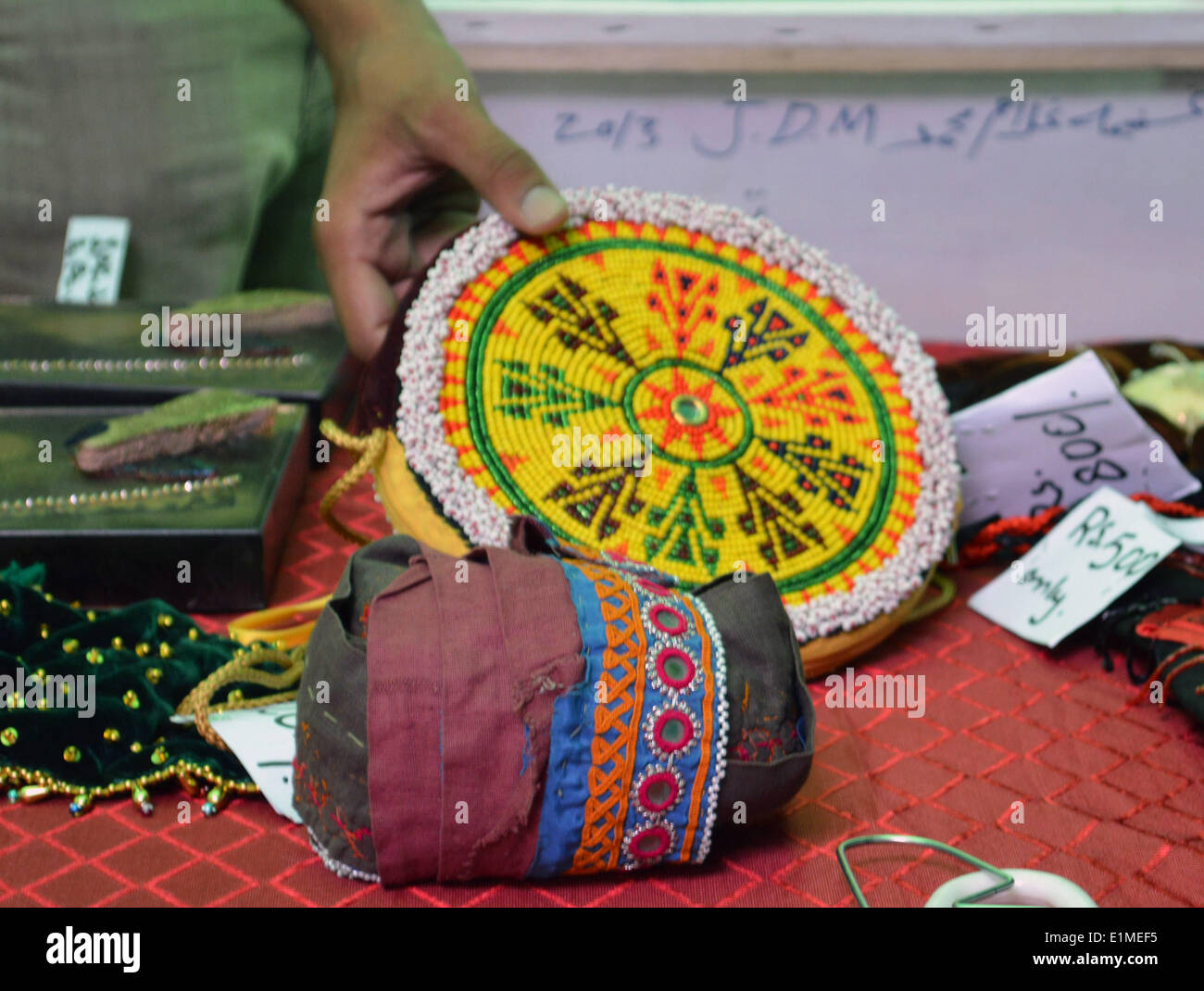 Quetta. 6th June, 2014. A woman shows a baluchi handicraft in ...
