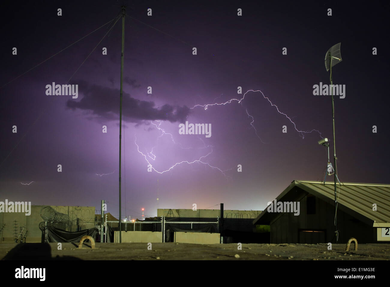 A dust storm carrying small amounts of rain sparks lightning across the ...