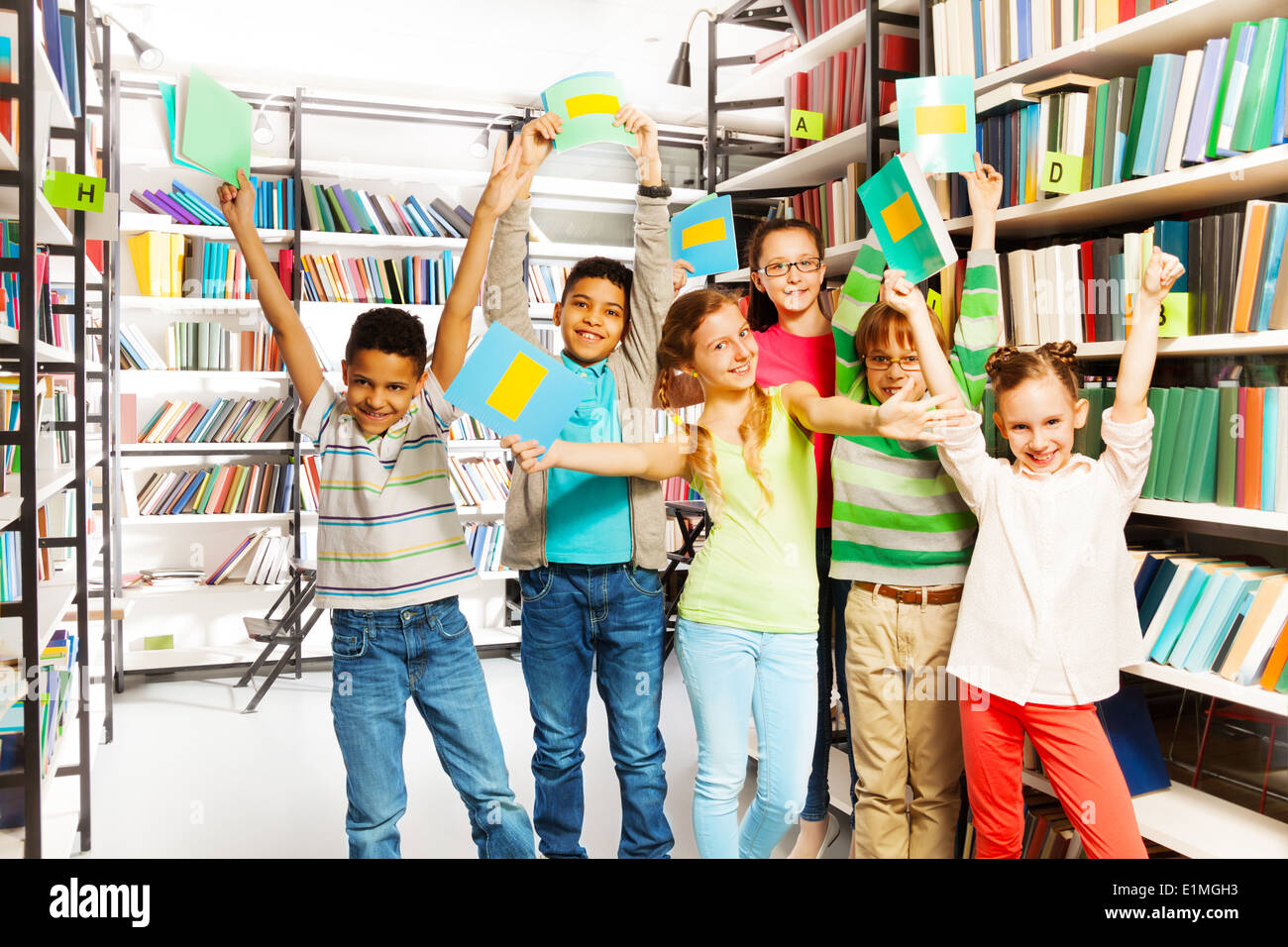 Happy holding up book child hi-res stock photography and images - Alamy