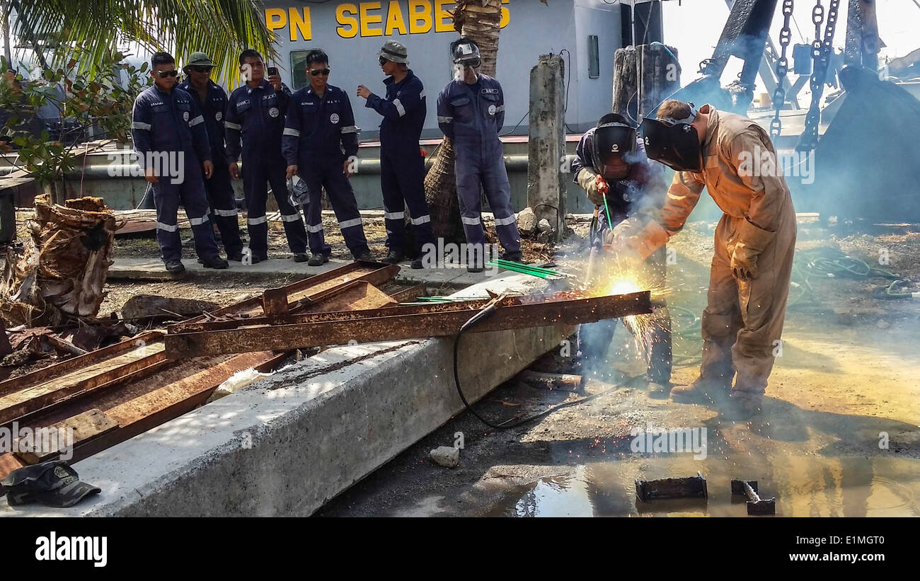 U.S. Navy Construction Mechanic 2nd Class Nate Emmett, right, with ...