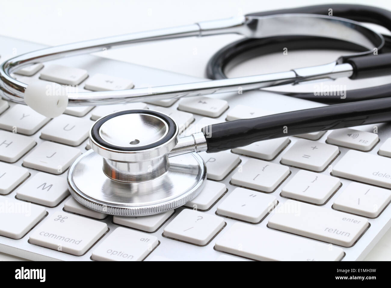 Stethoscope isolated on white background with a modern computer ...