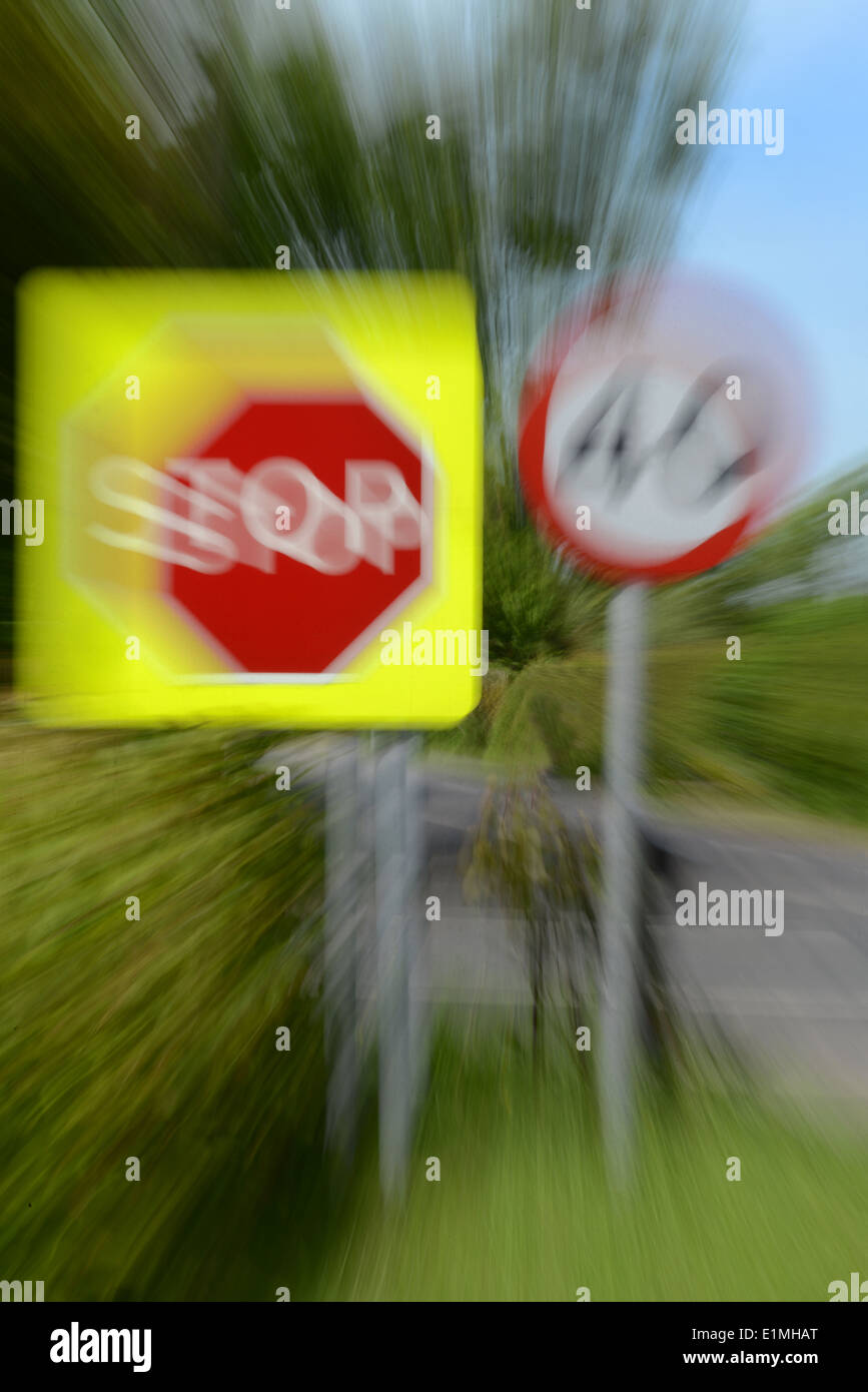 zoom exposure of roadside stop sign and 40 mph warning sign at road ...