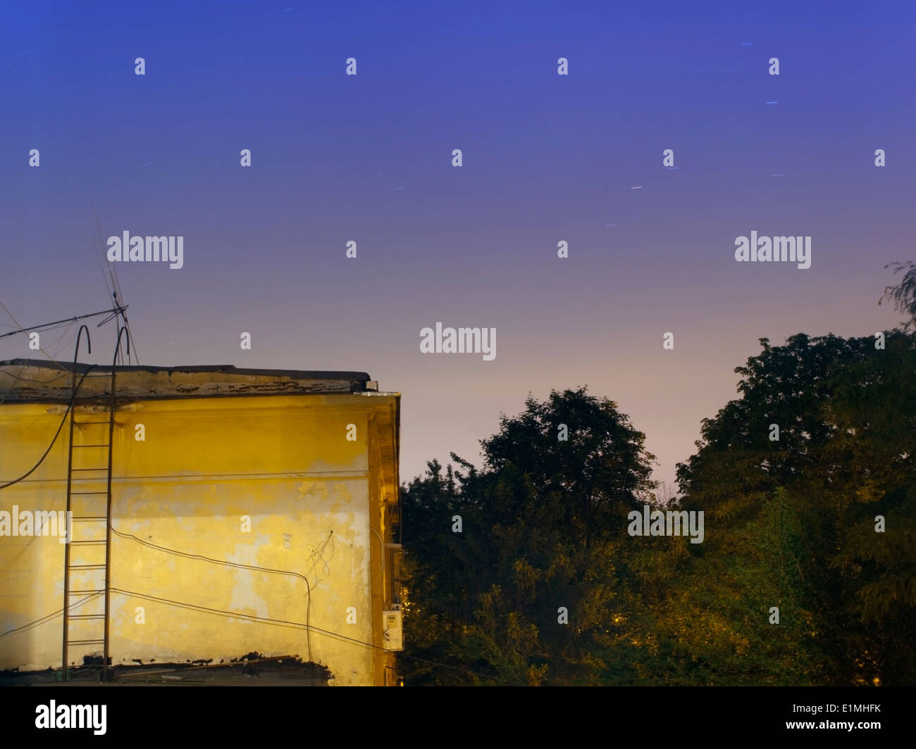 Starry night falling over a block of apartments Stock Photo - Alamy
