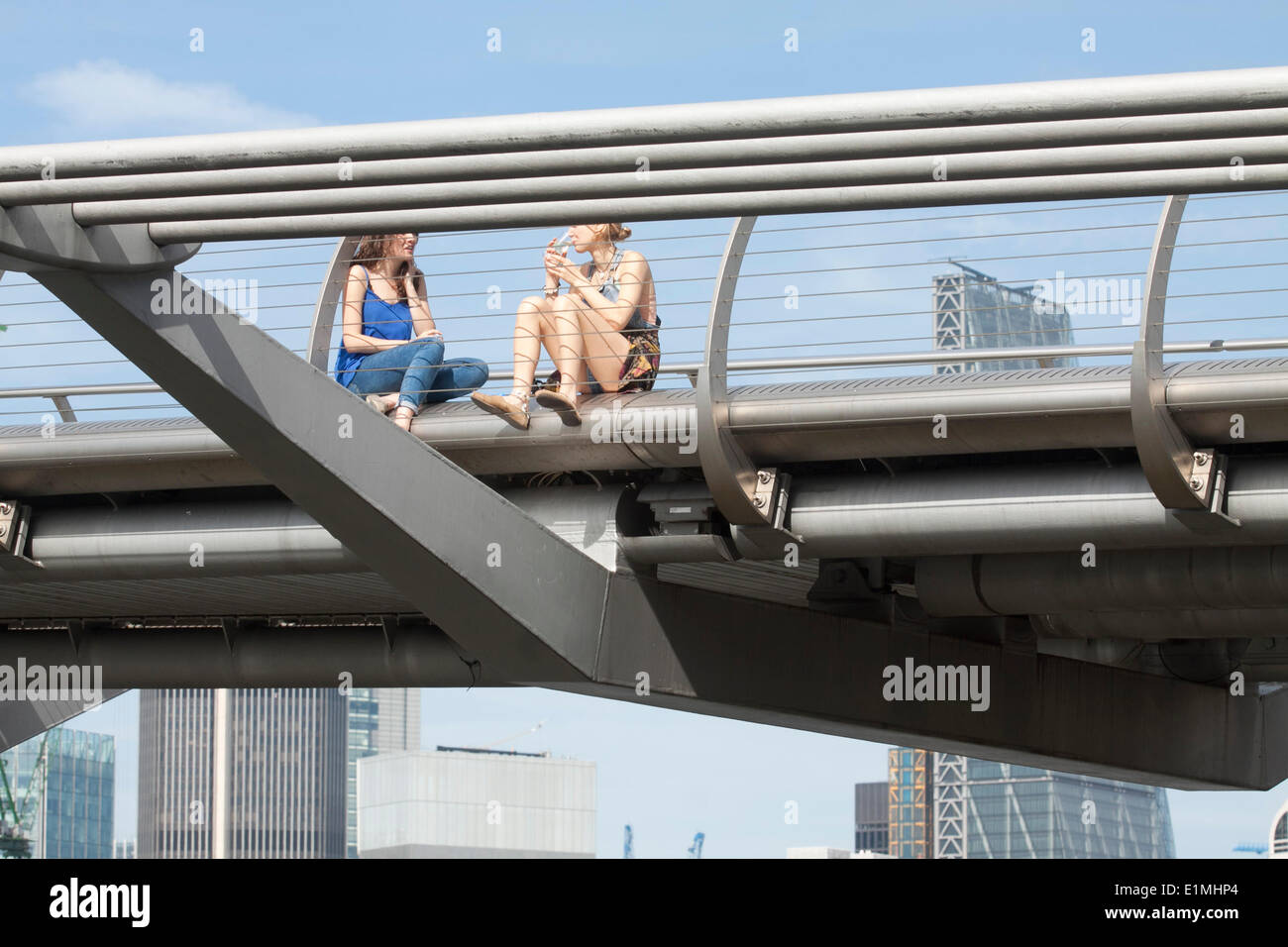 London UK. 6th June 2014. two girls sit on the Millennium bridge on a ...