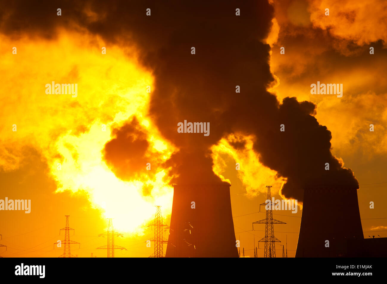 Smoke from pipes on sunset background Stock Photo - Alamy