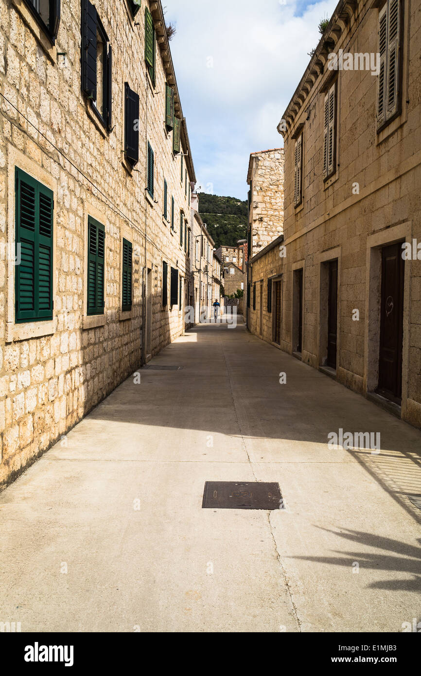 A shaded back street in vis town showing contrast between green ...