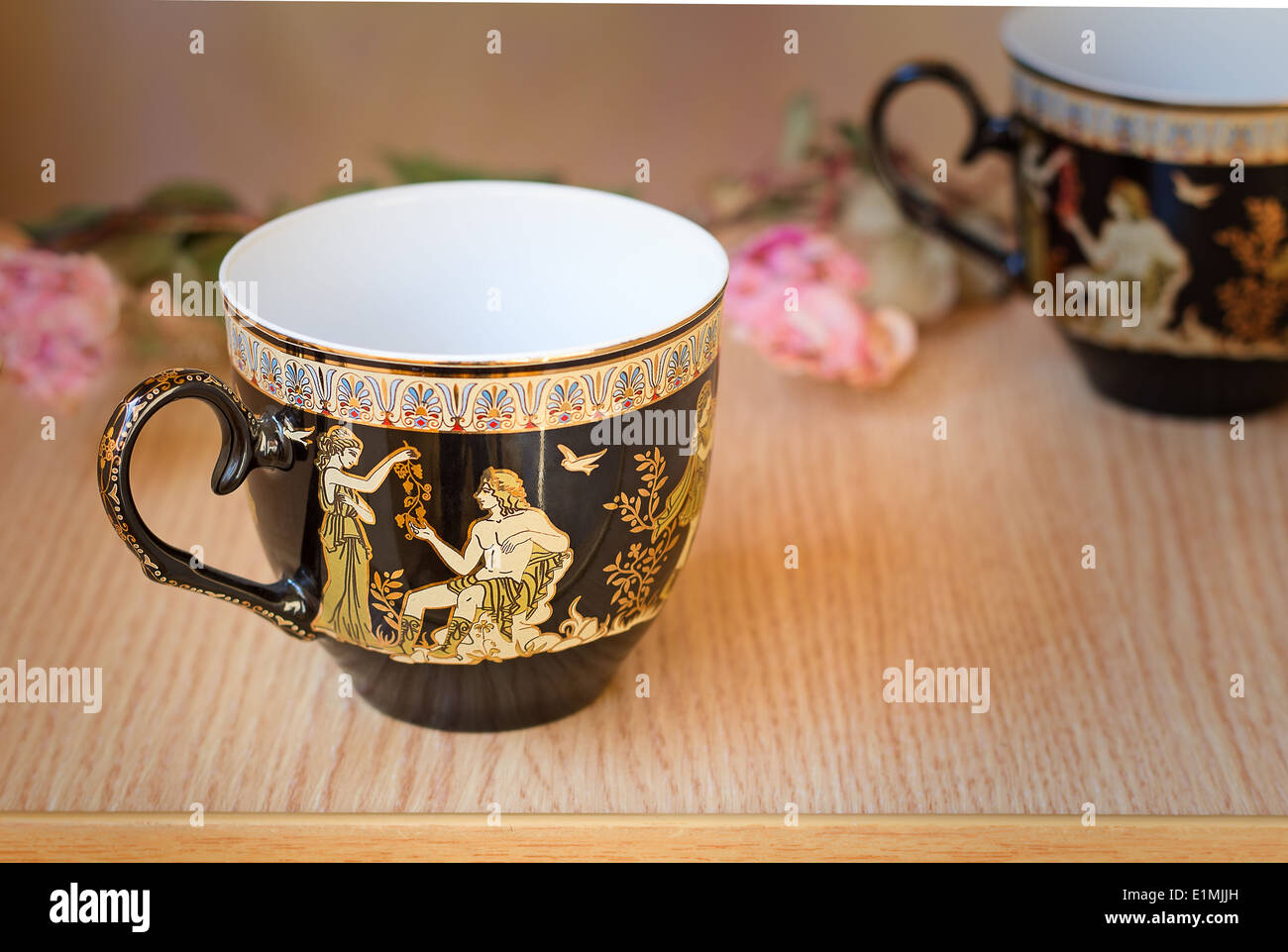 The beautiful tea cups decorated with a list with gold with the image ...