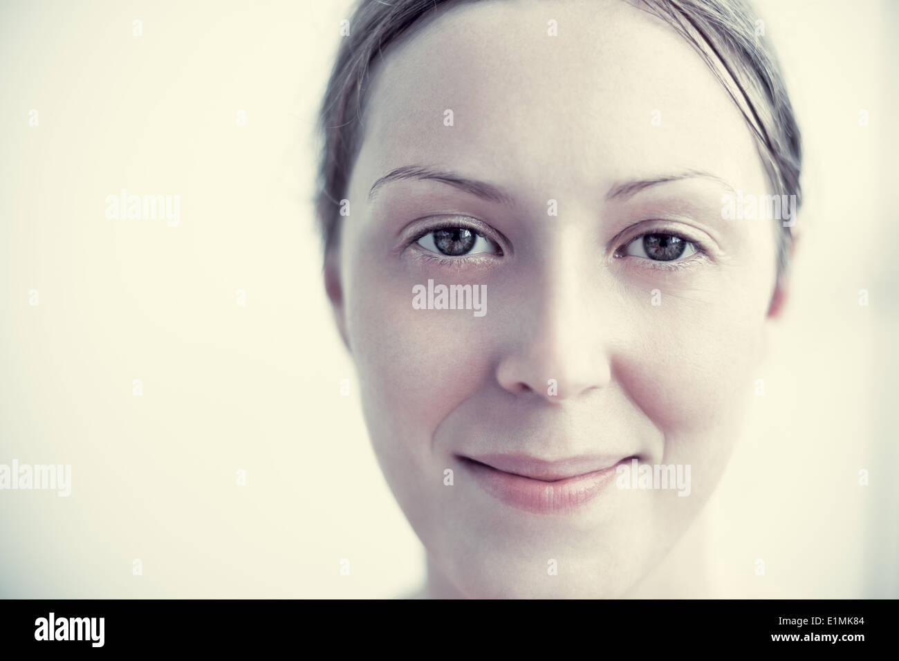 Young woman portrait. Soft yellow tint Stock Photo - Alamy