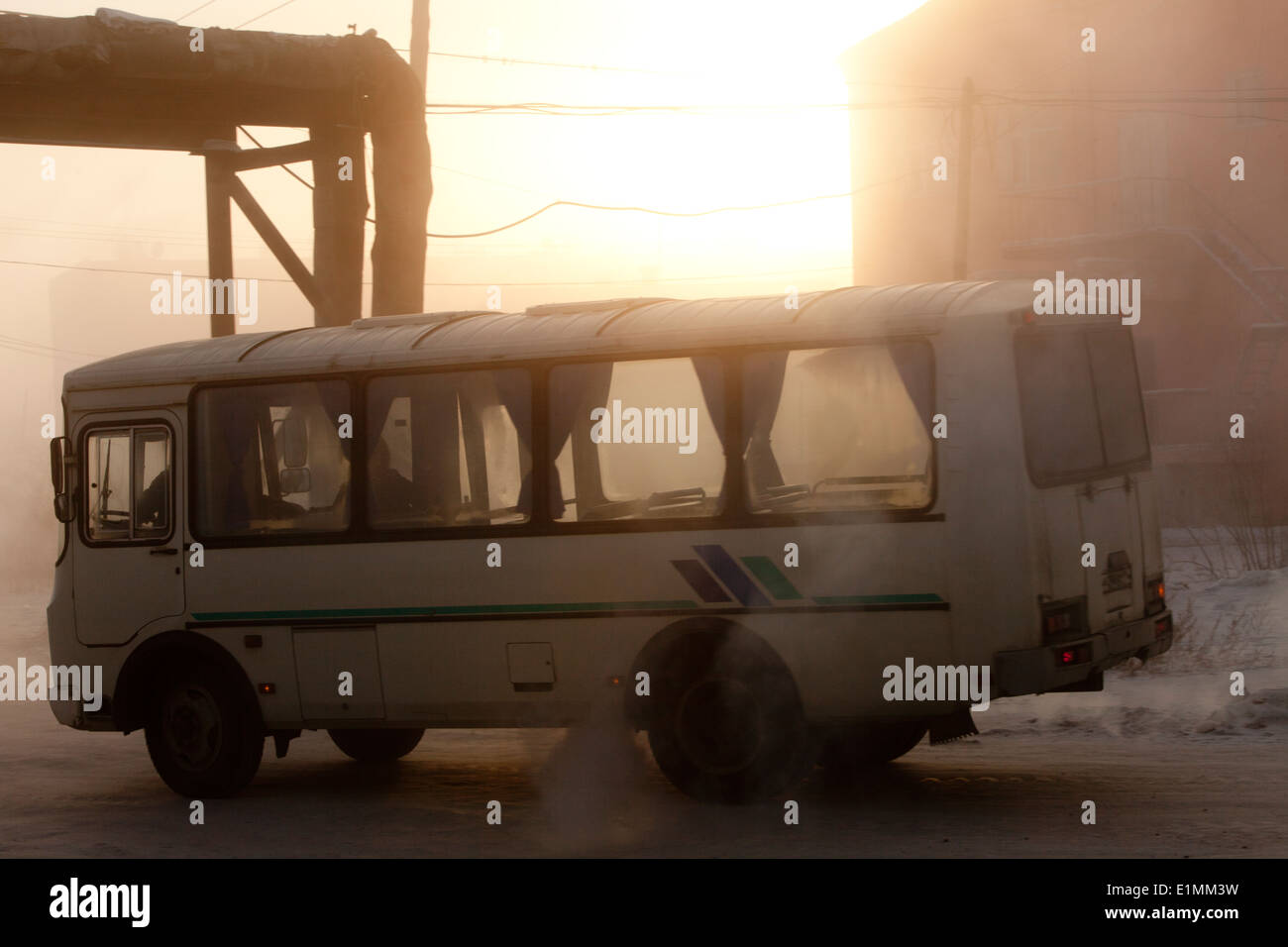 early morning bus cold sun silhouette snow siberia Stock Photo - Alamy