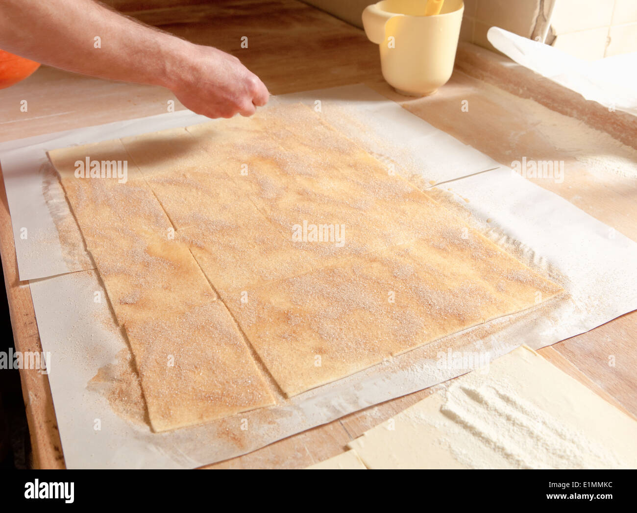 Professional Bakery - Adding Sugar on Top of Pastry Stock Photo - Alamy