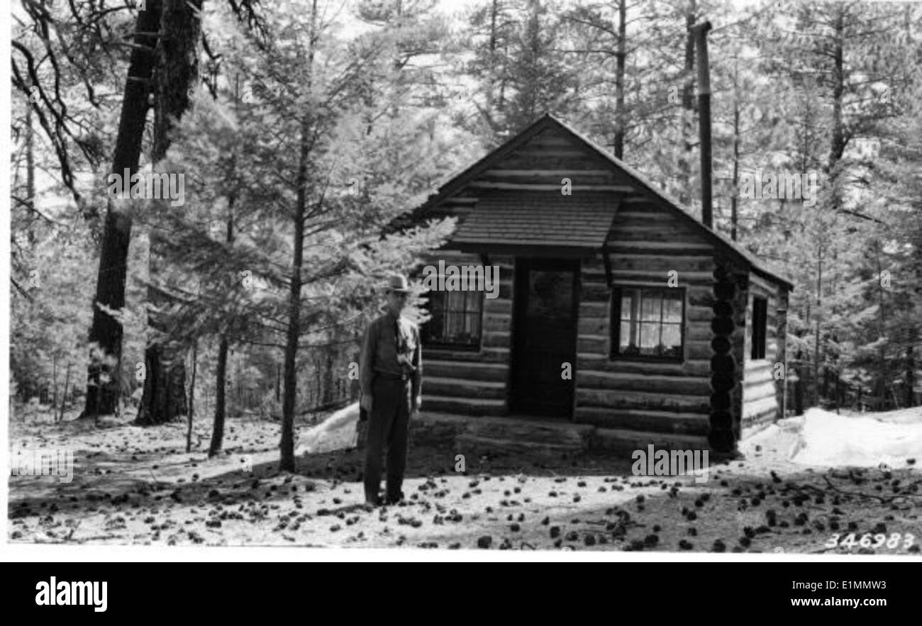 A historic black-and-white photo shows a man in a forest, possibly part ...
